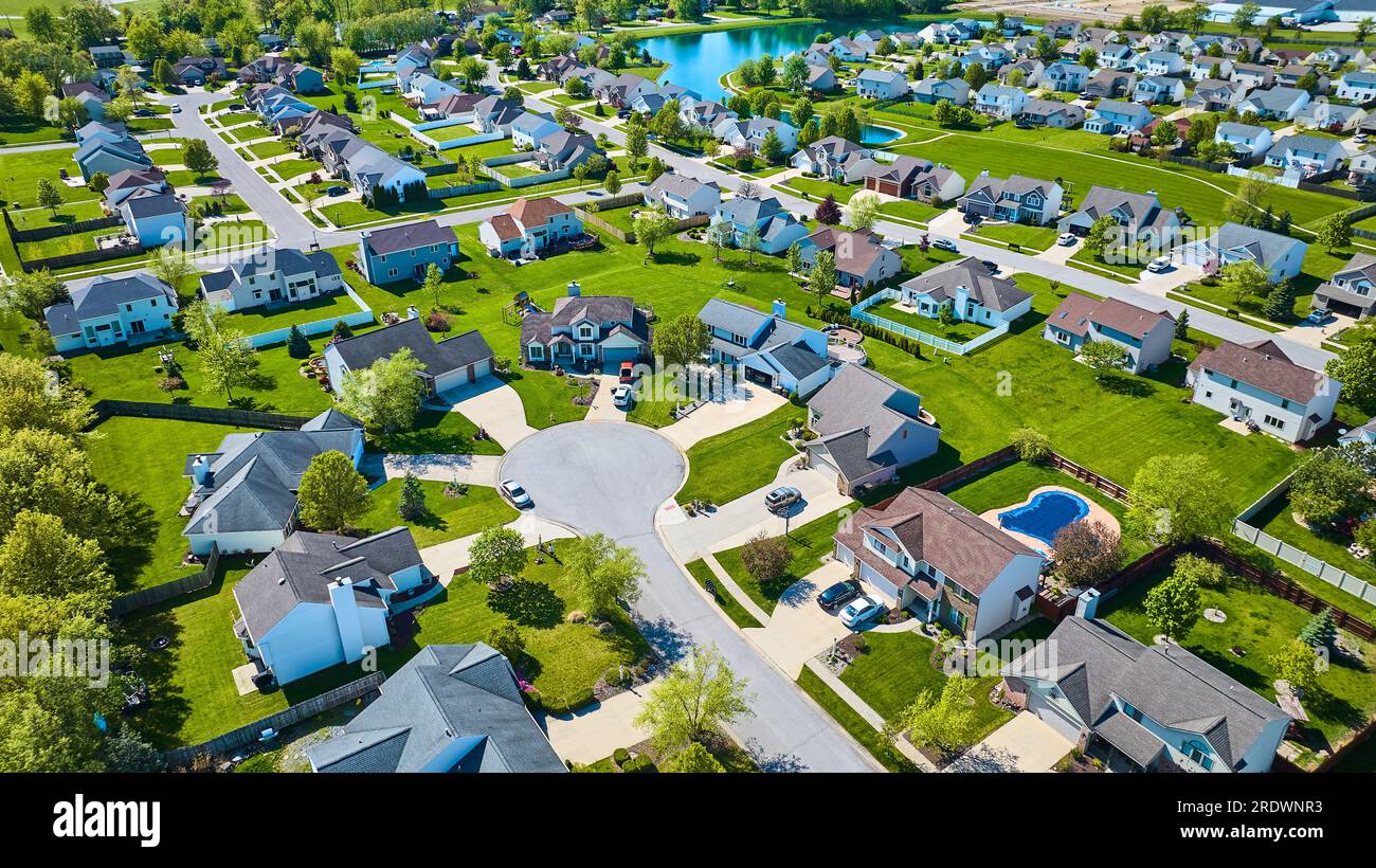 Various sized homes in large suburban neighborhood aerial and pond ...
