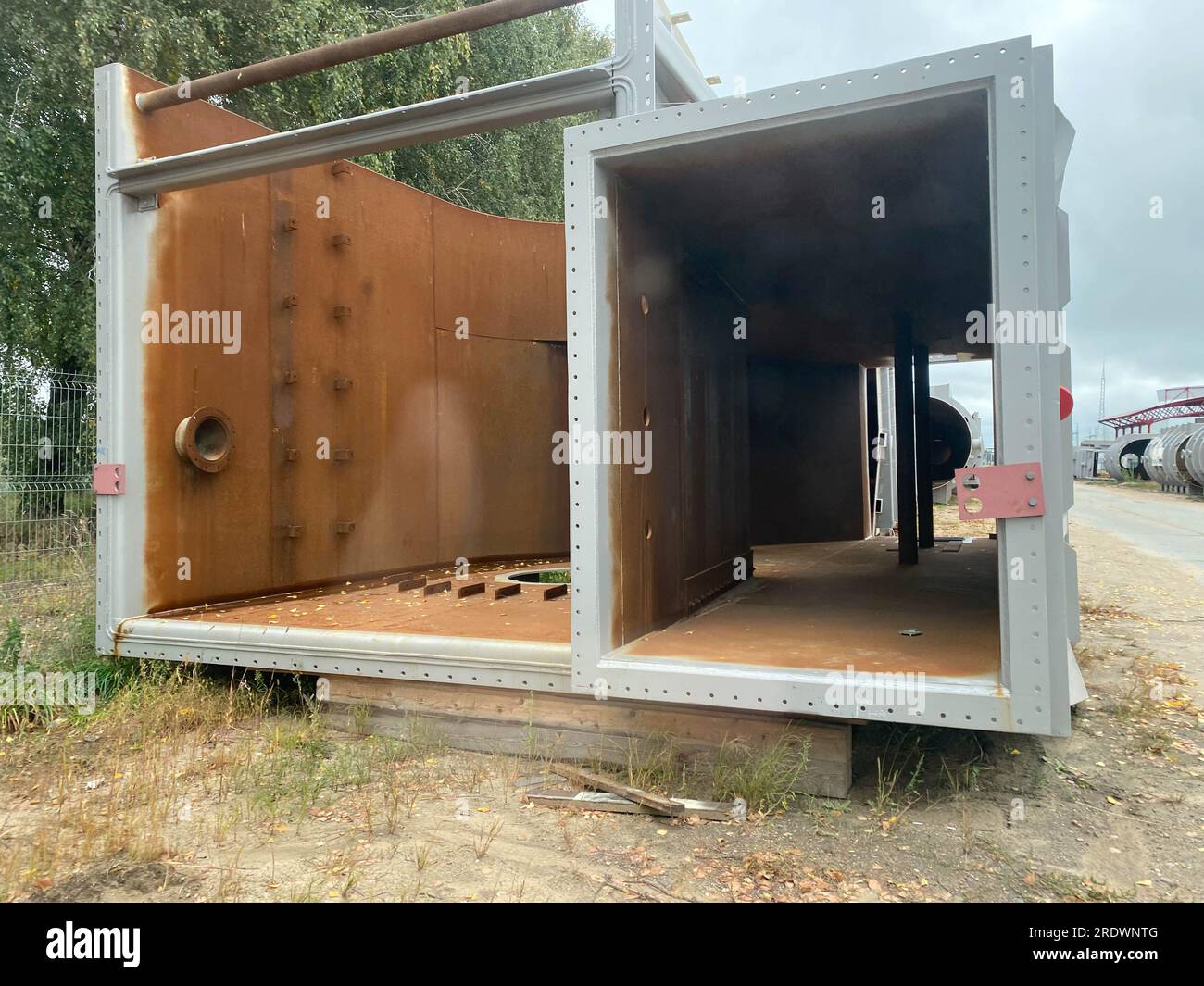 Large industrial warehouse in the open air for storing iron metal pipes ...