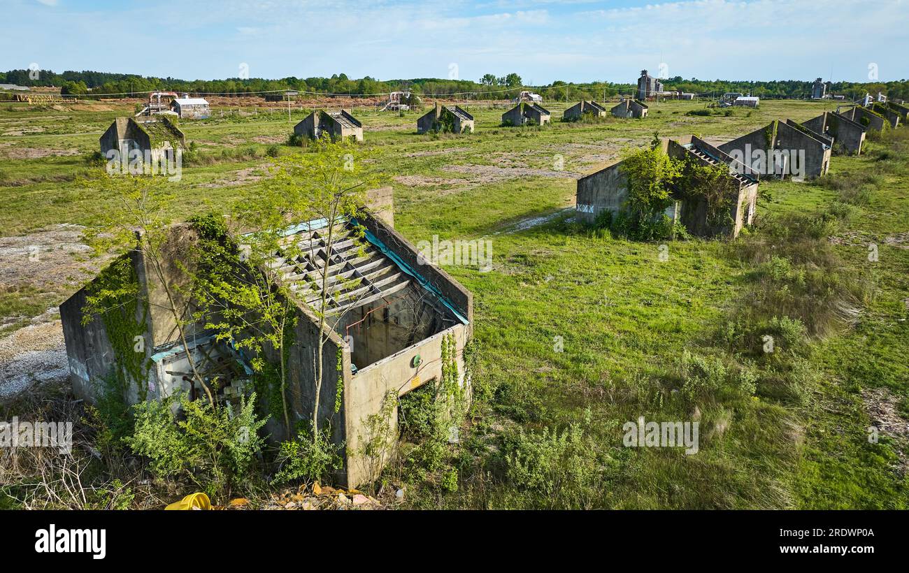 Identical abandoned structures middle of nowhere grassy field, decay ...