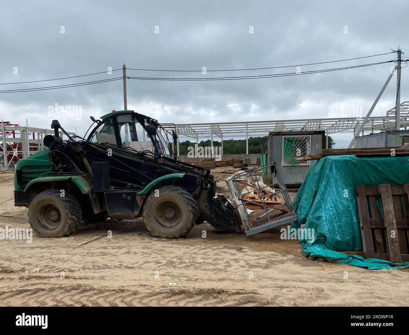 A front-end loader at a construction site removes debris from ...
