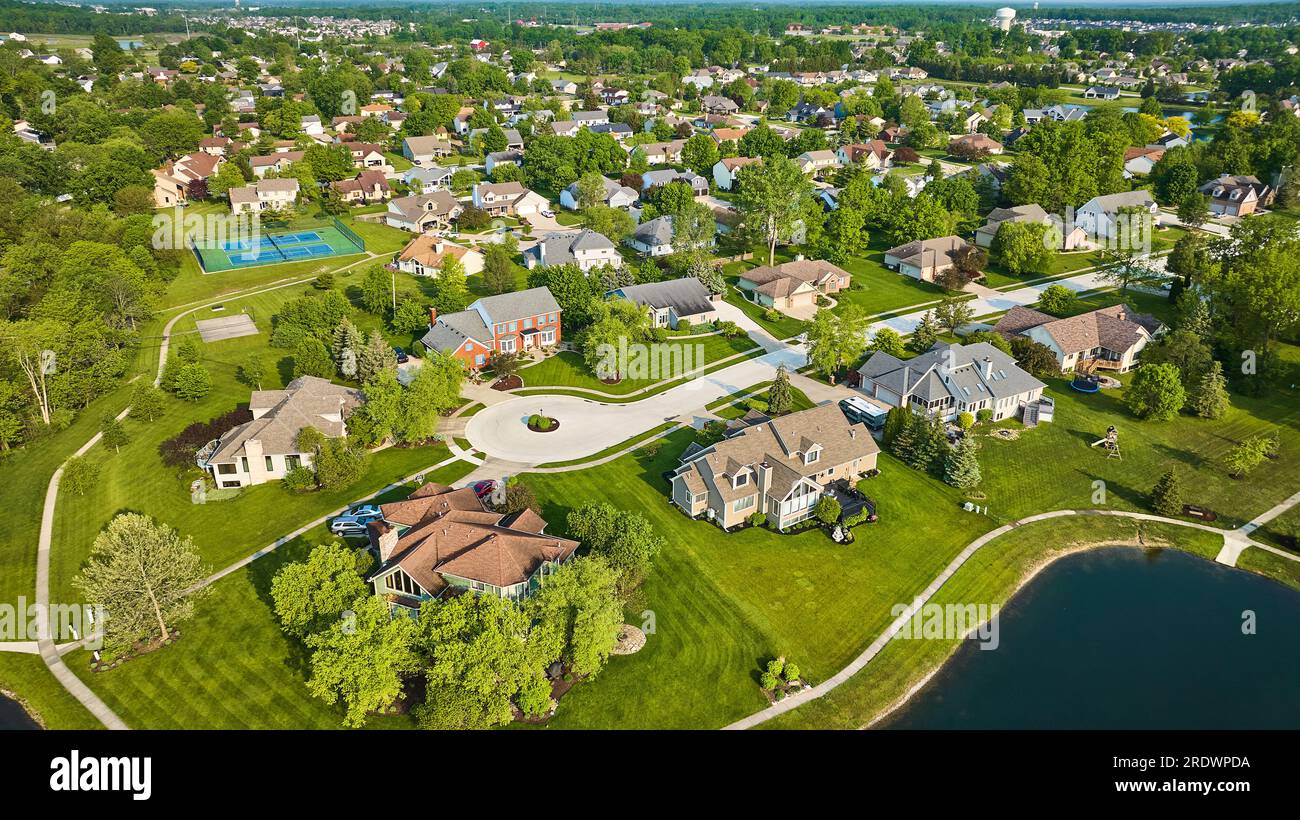 Neighborhood housing addition white paved street nearby tennis court ...