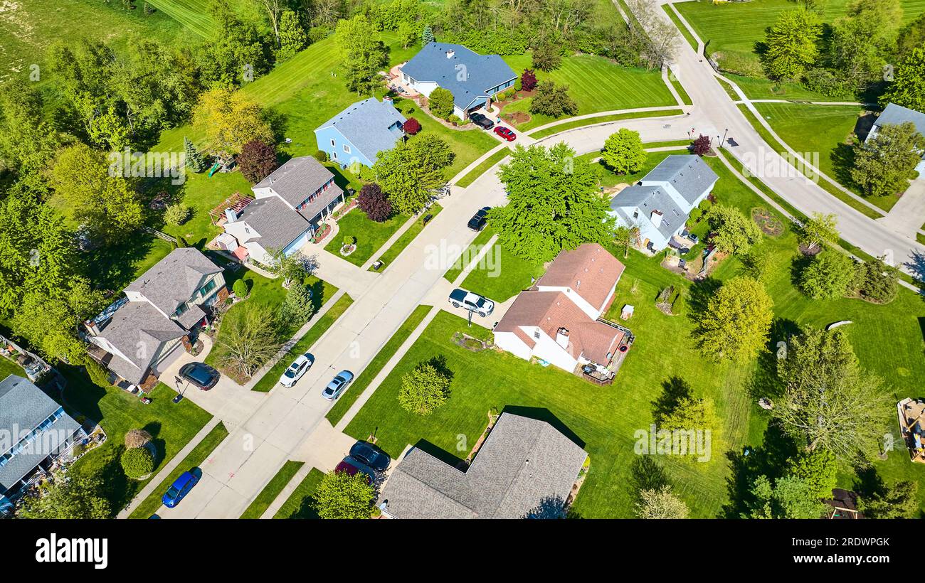 Clean white roads winding through small neighborhood with blue and ...
