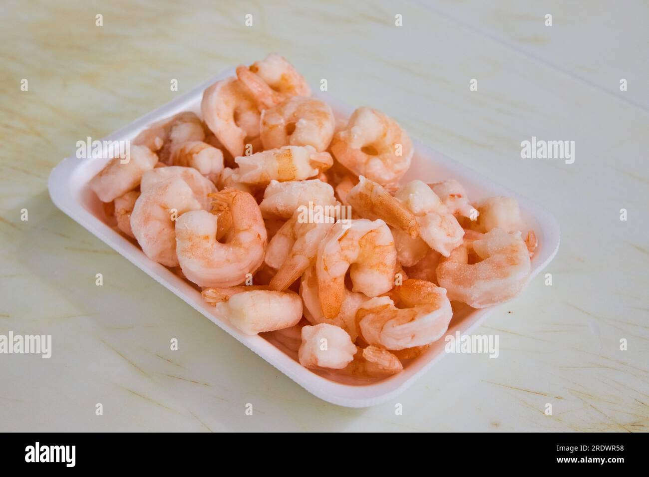 Pile pink cooked shrimp, seafood on white tray, grocery store, meat ...