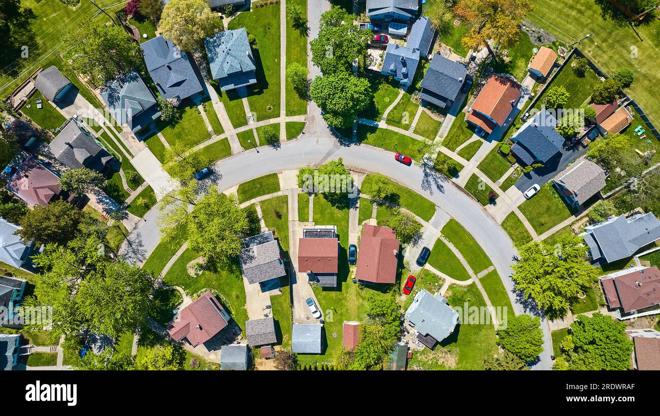Aerial houses on circular road HOA neighborhood green summer lawns ...