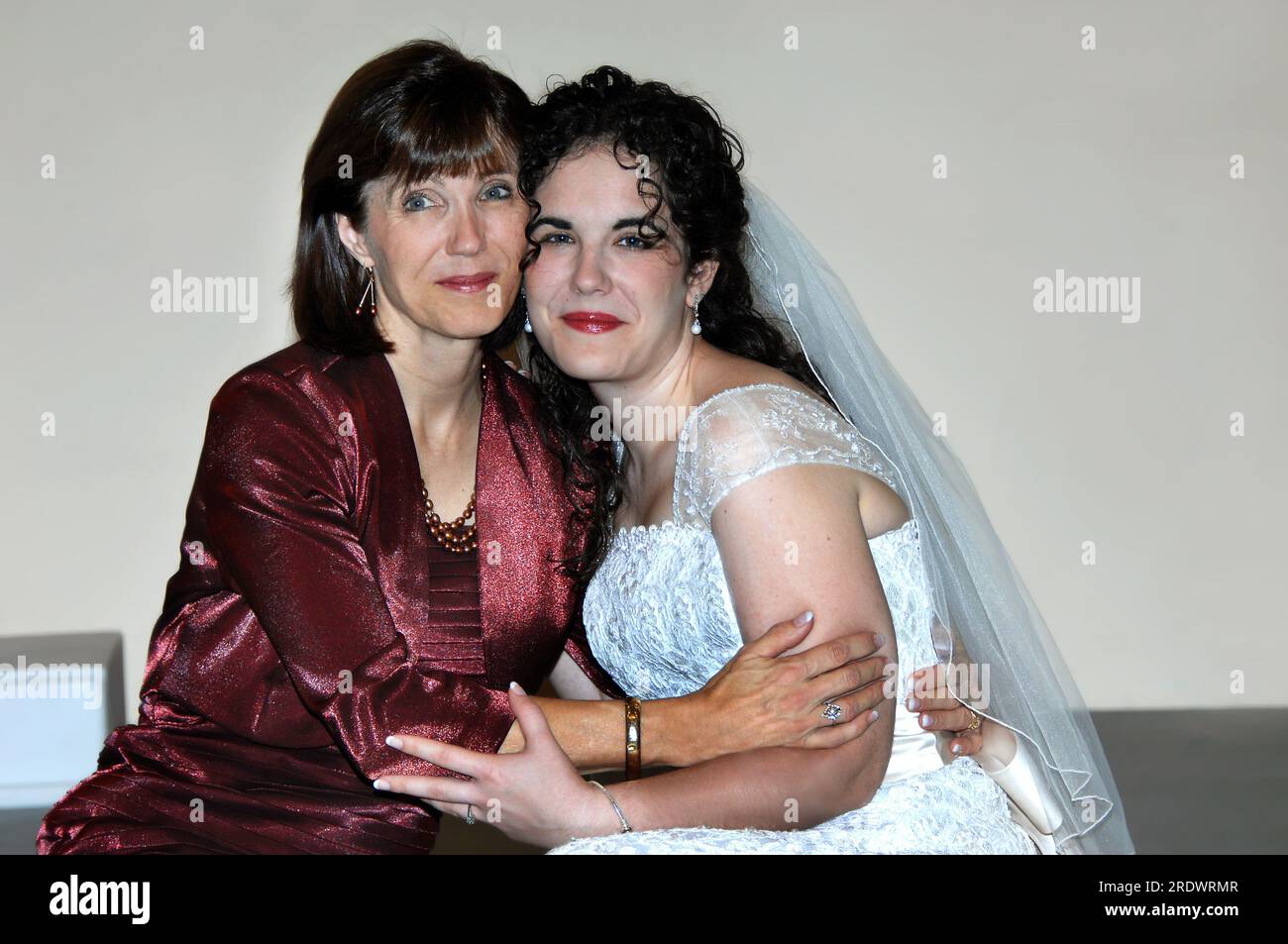 Bride and mother cling to each other before the ceremony starts ...
