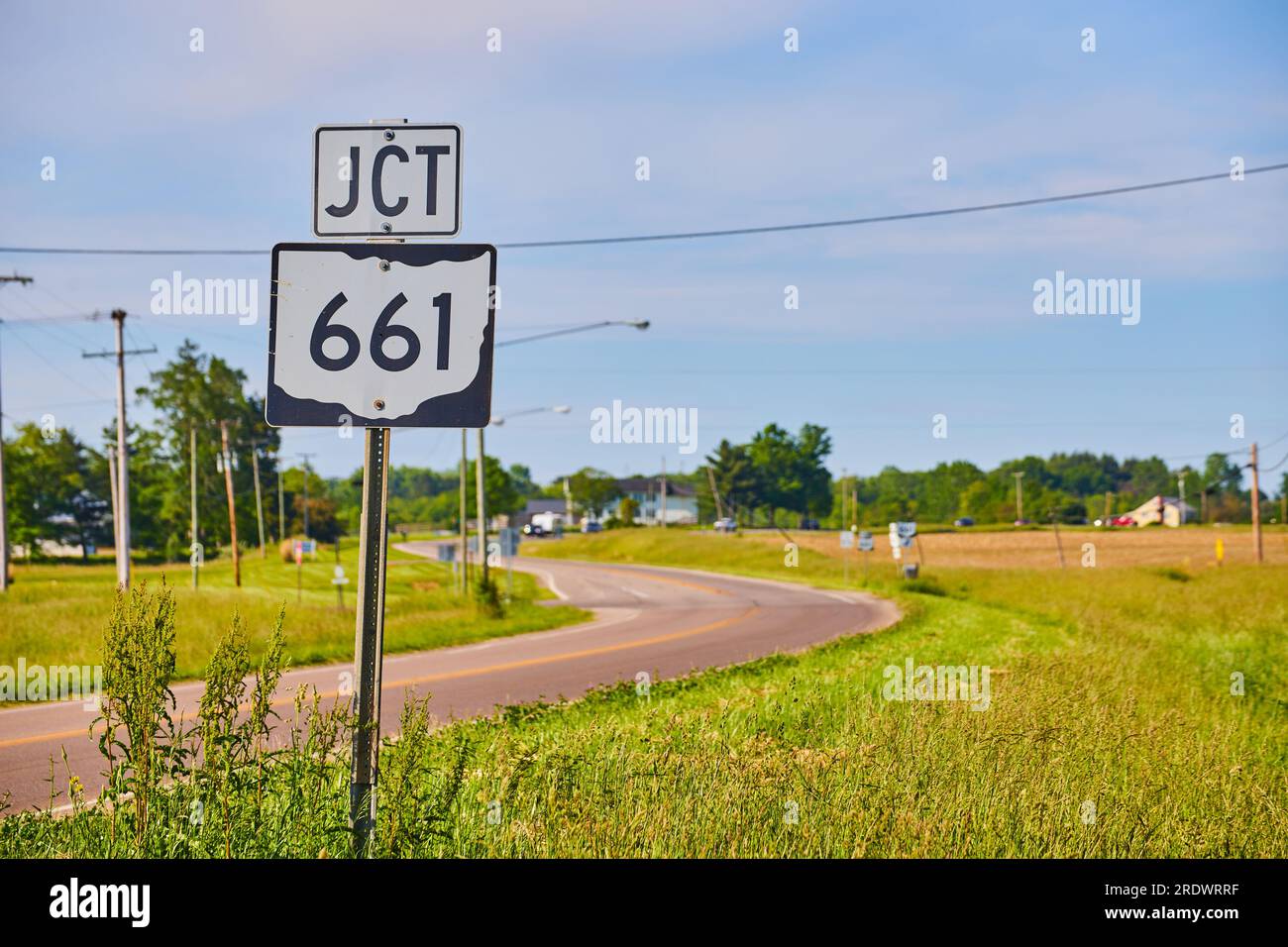 JCT 661 sign next to highway in summer with blue sky and thin clouds ...