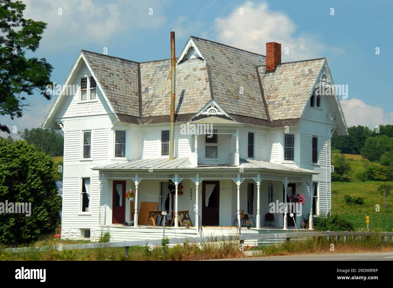 Old Victorian Farm House is painted white including the scroll work beneath the eaves and porch ...