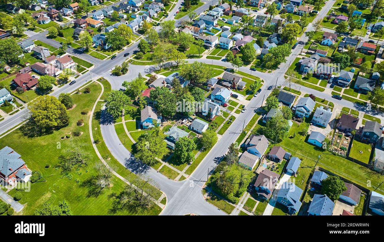Large aerial neighborhood in summertime with large green trees in city ...