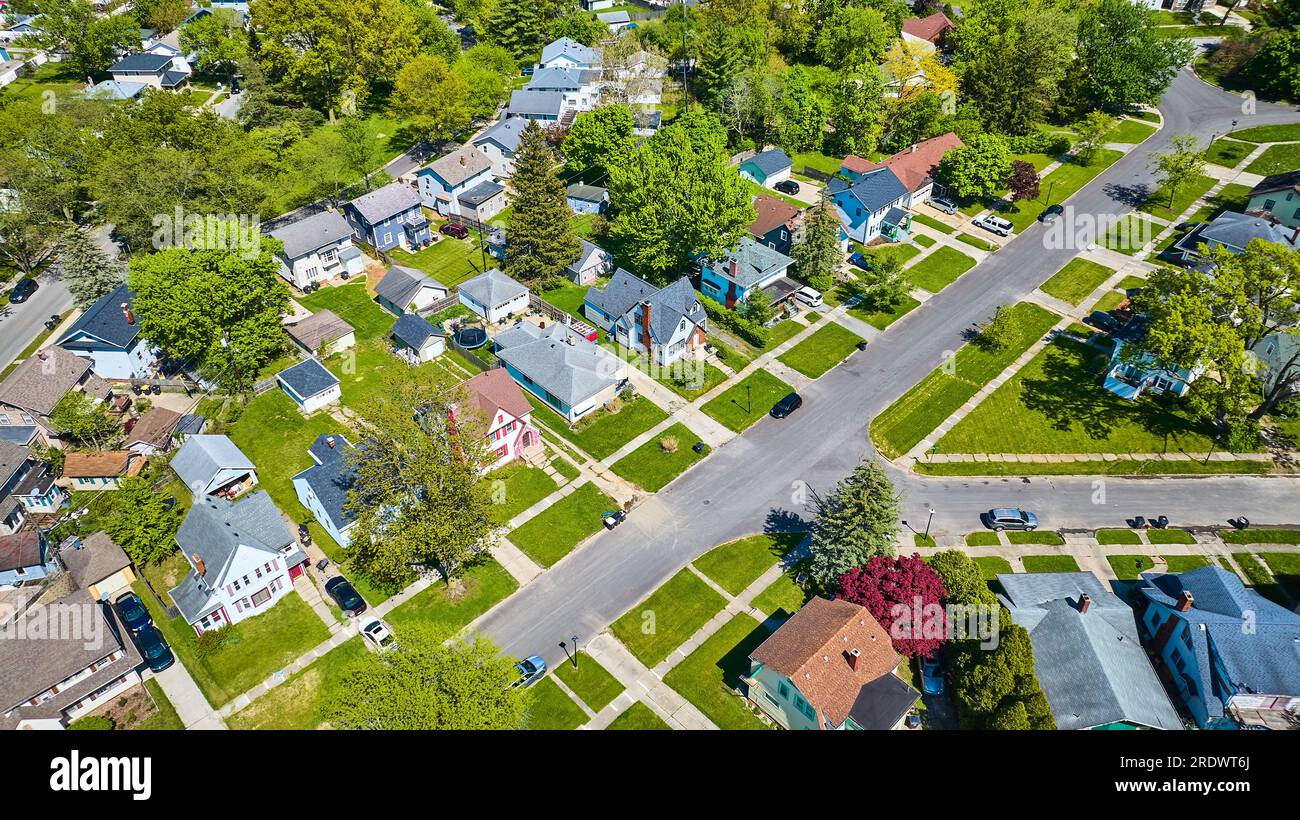 Two story houses neighborhood straight street aerial summertime trees ...