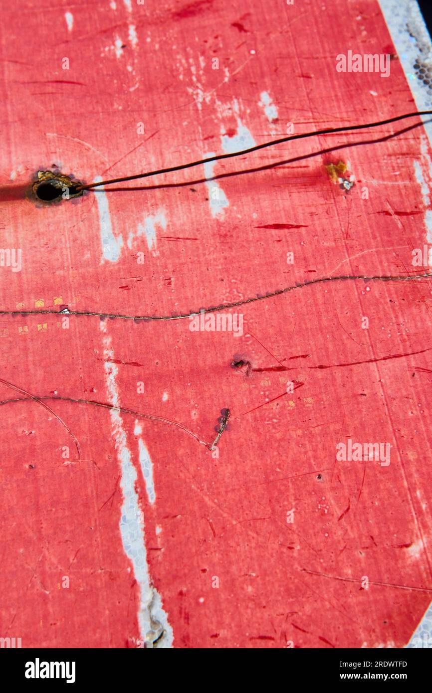 Old, faded colors on sign, chipped, fading red paint, metal texture ...