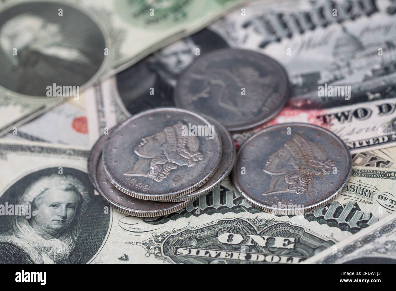 Old west US banknotes and silver certificates with silver dollar coins ...