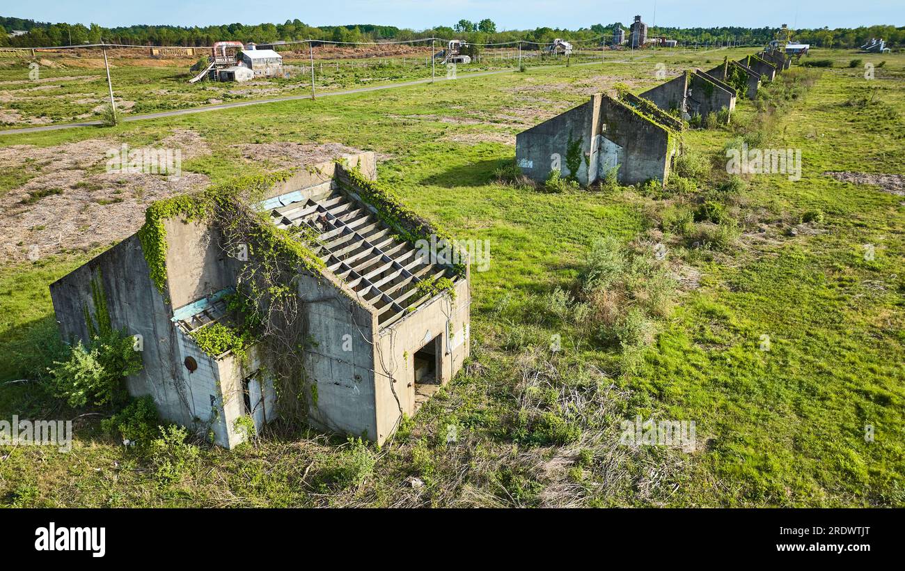 Slat roof structures abandoned buildings decaying in green field ...