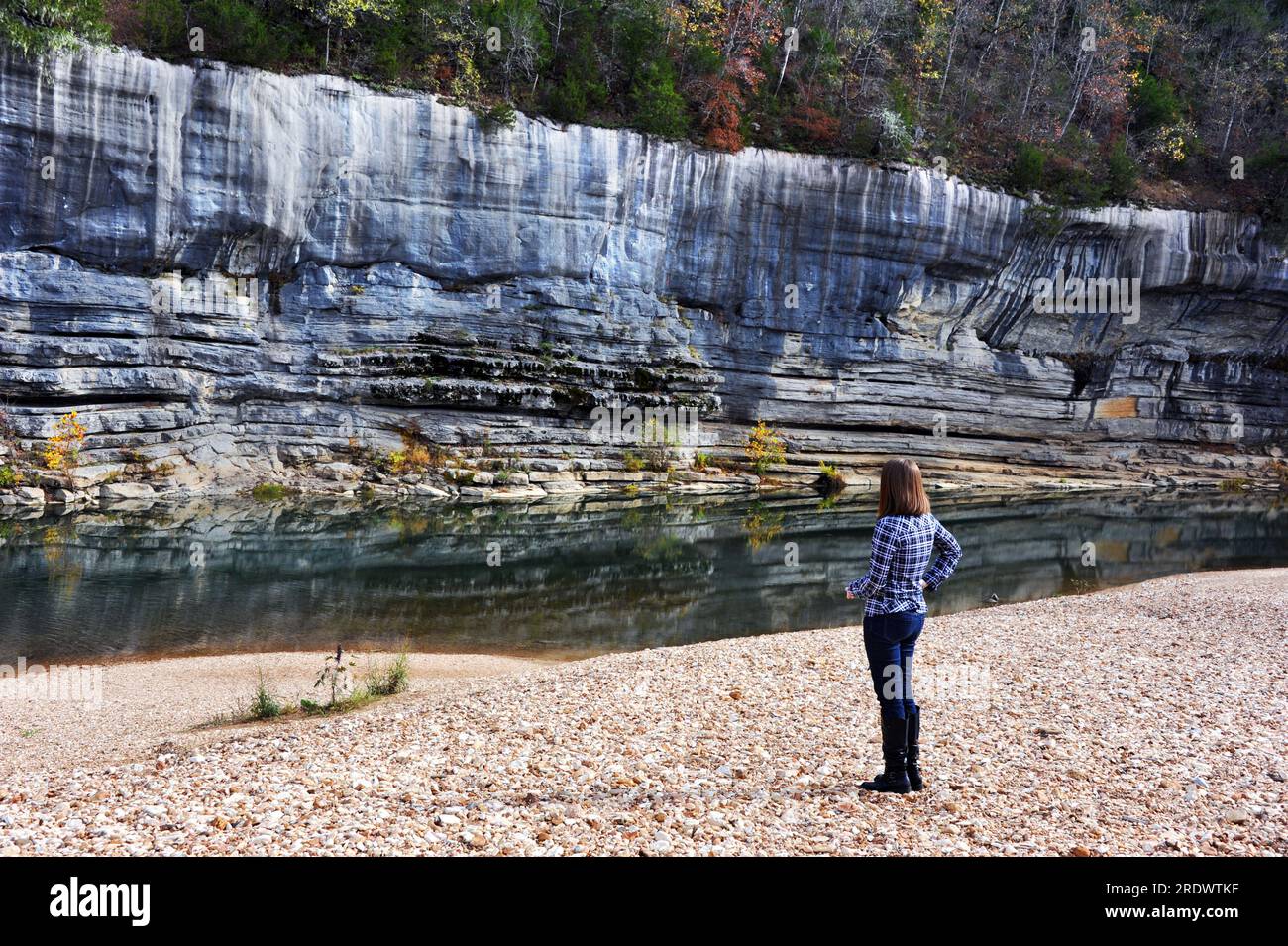 Woman stands and admires the rugged cliffs of the Buffalo National ...