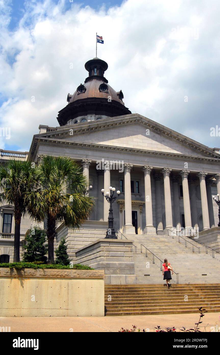 Young woman climbs the steps of her courthouse on her way to the ...