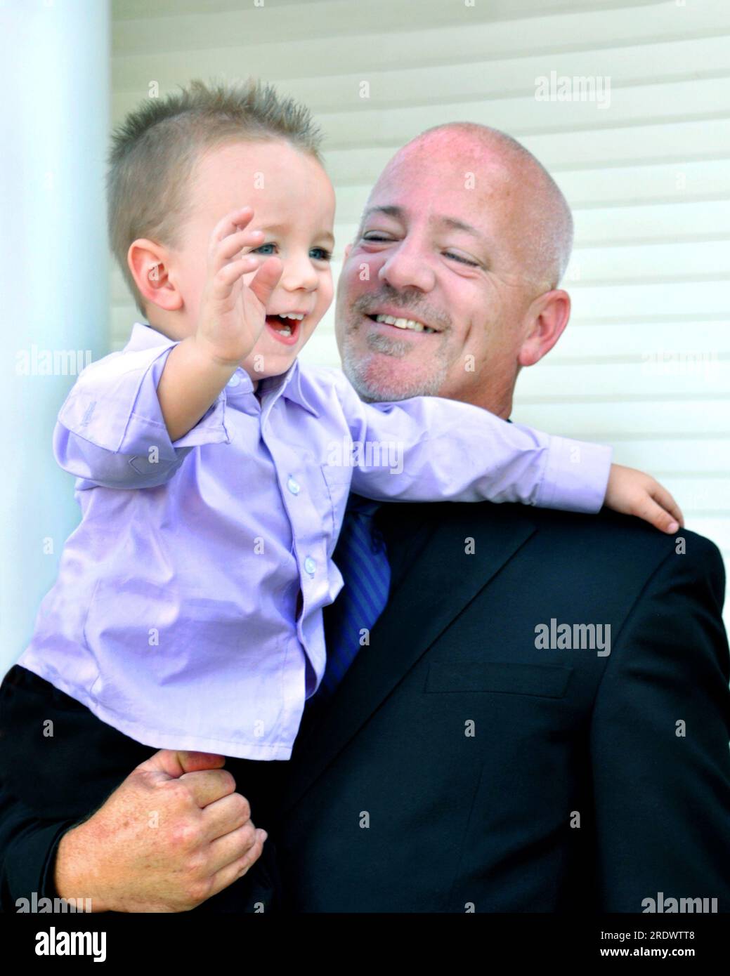 Little boy gives a joyful reception to his Mom. He is beaming and ...