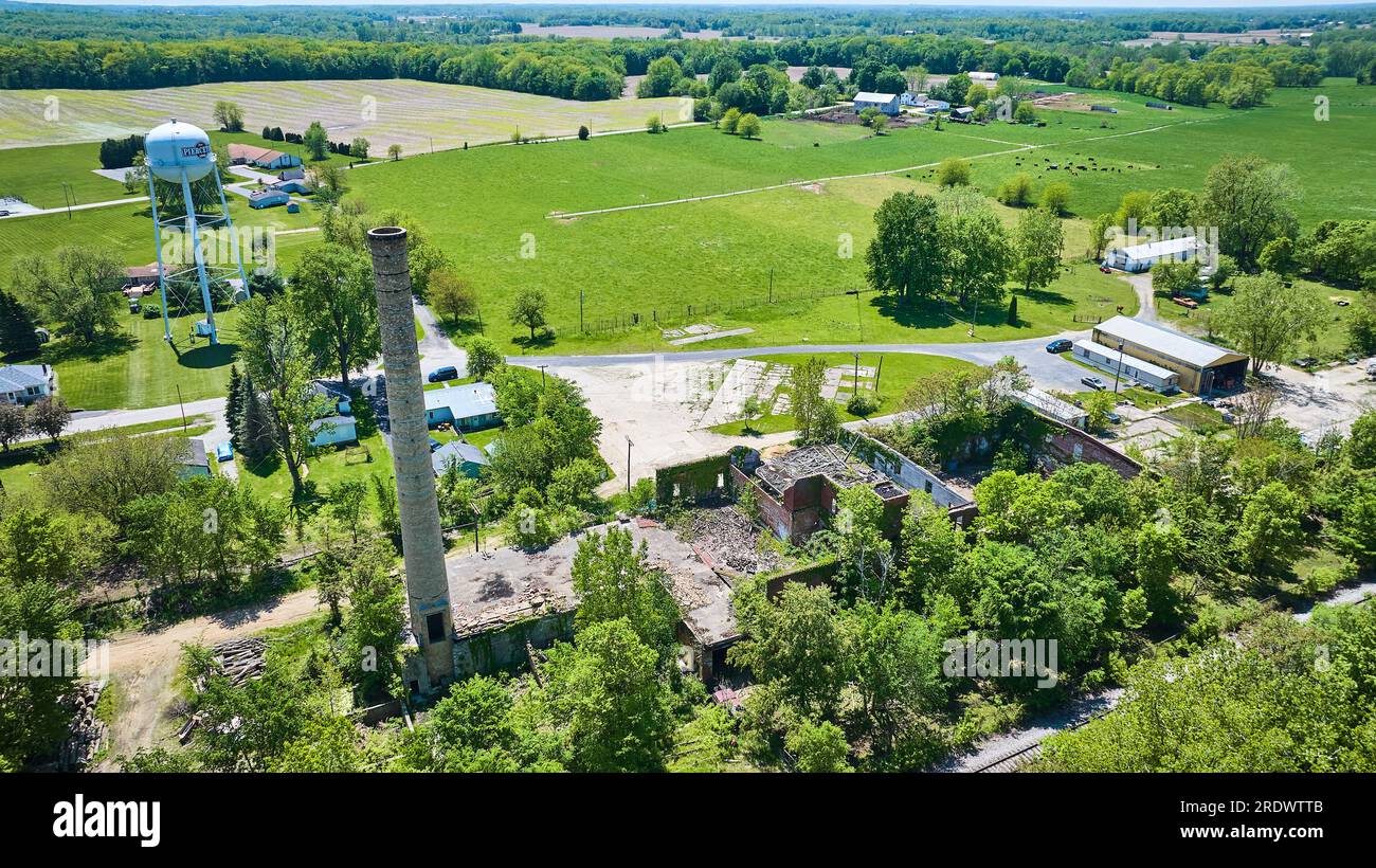 Summer farm farmland, abandoned run down building caved in roof with ...