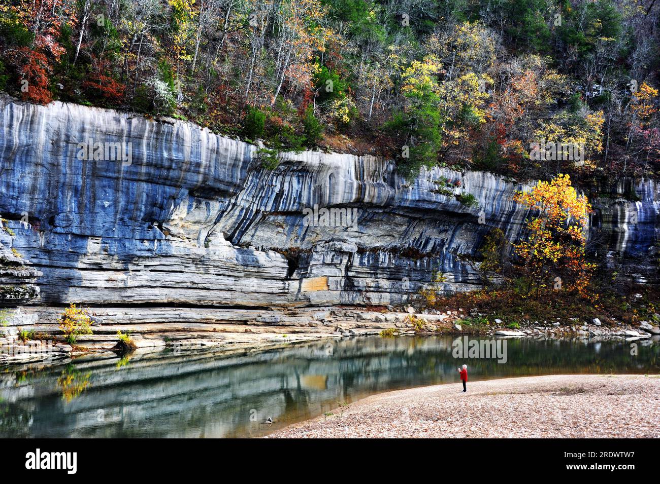 Tall cliffs of the Buffalo National River are streaked with grey, black ...