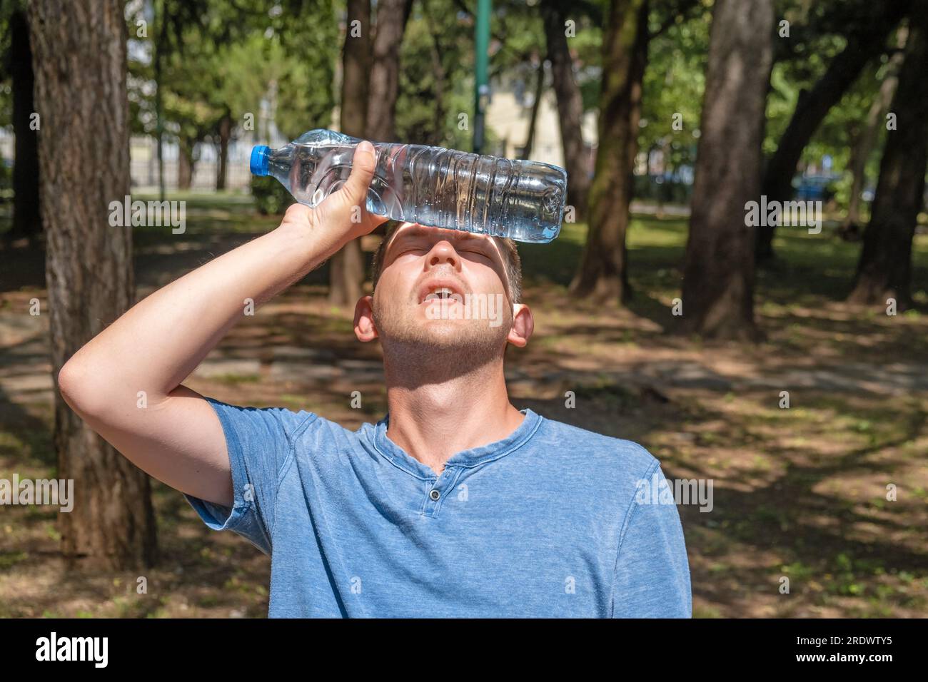 Man suffering from heat, guy with heatstroke. Caucasian male presses ...