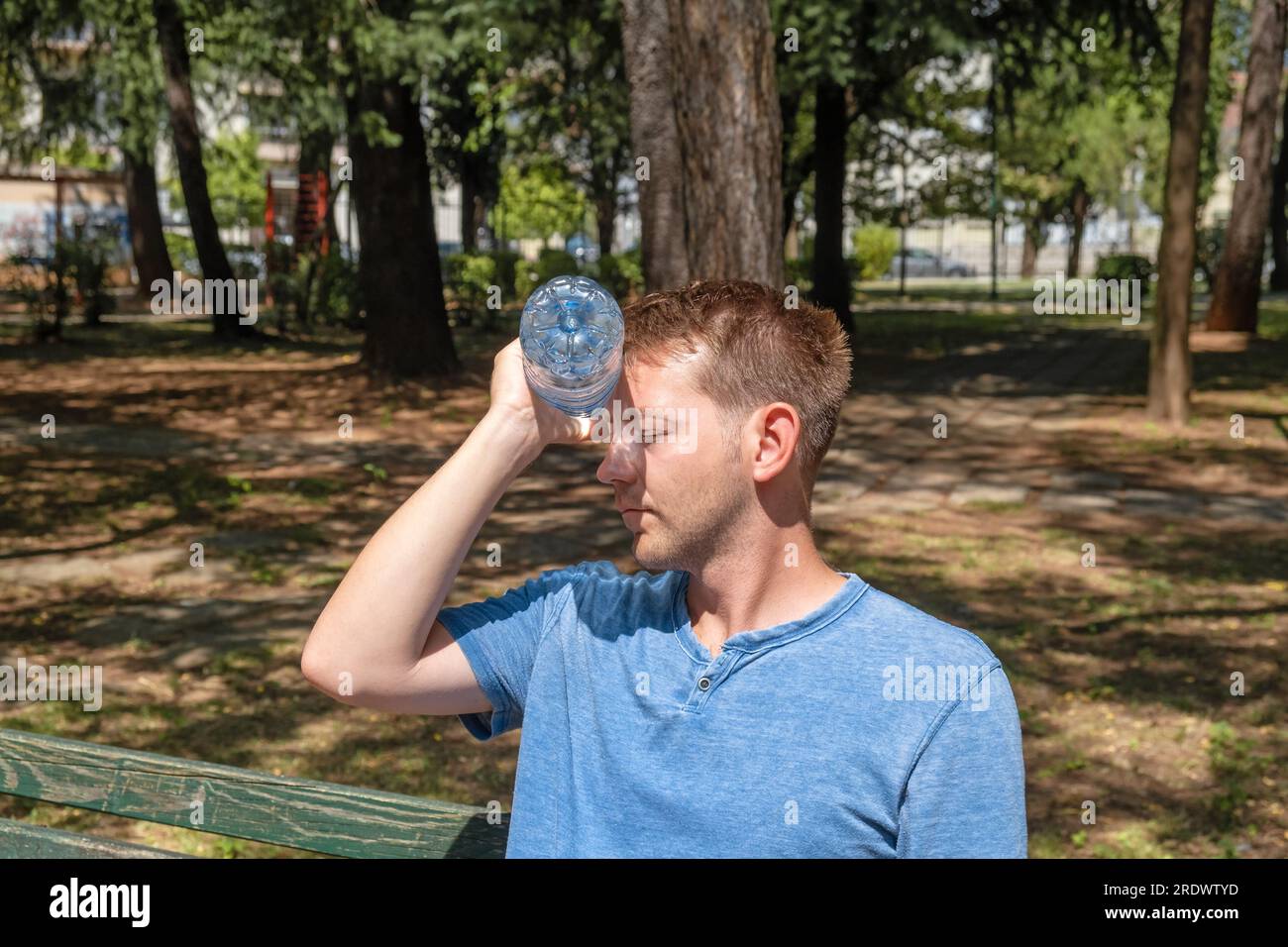 Man suffering from heat, guy with heatstroke. Caucasian male presses ...