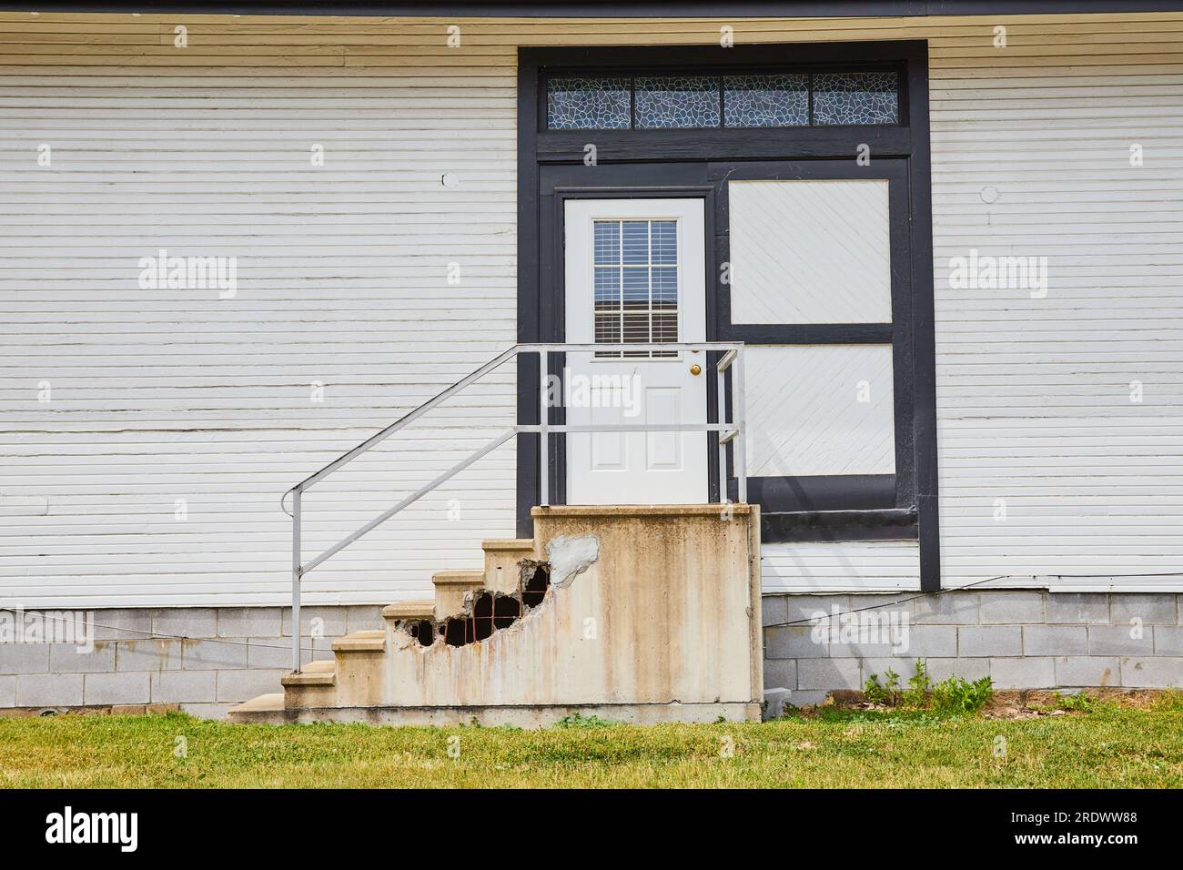 Exterior white house with white door with stained glass mosaic windows ...