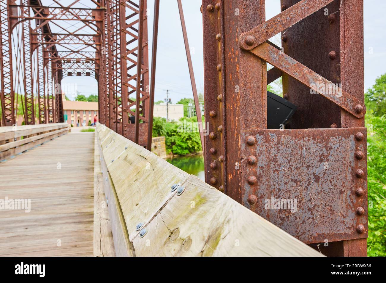 Close up of rusting iron beam with rivets and truss metal on wooden ...