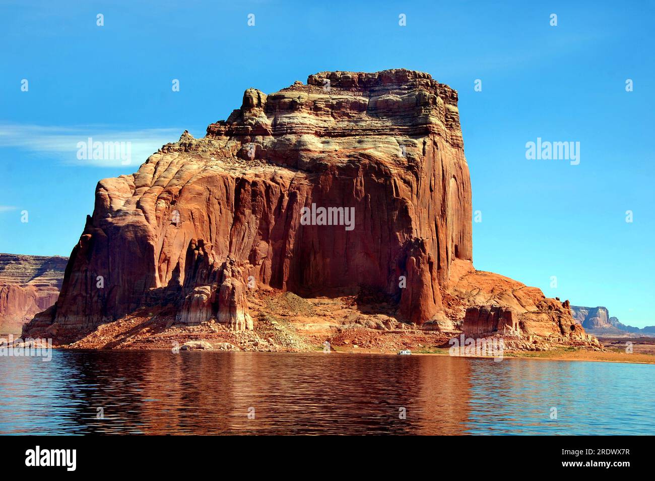 Beautiful sandstone rocks and cliffs tower over houseboat on the ...