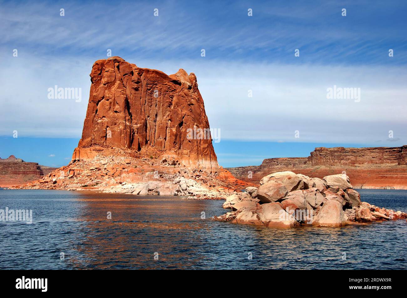 Big and small rocks line the shore of Lake Powell. Mesas and monoliths ...