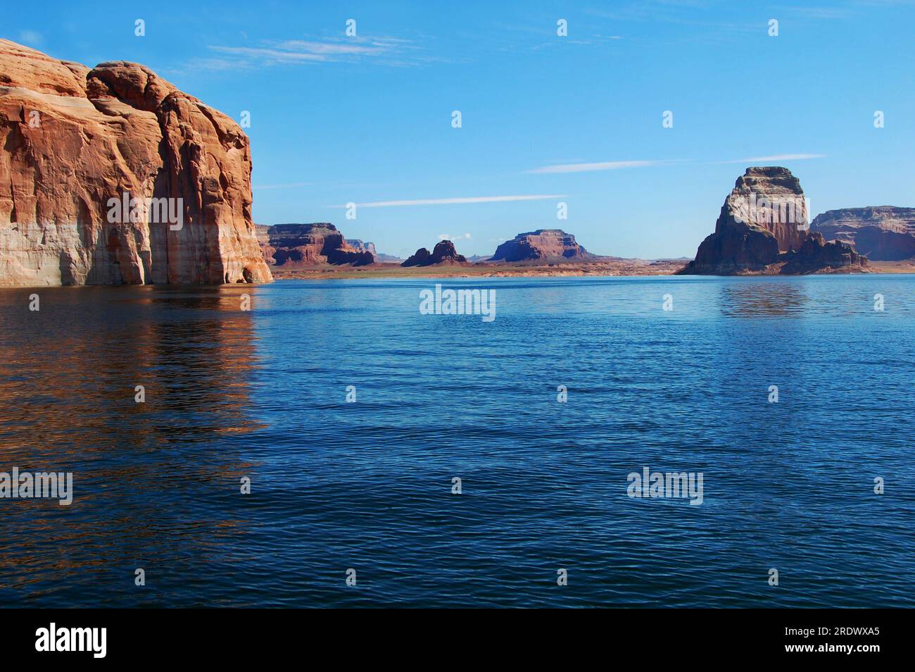 Landscape is filled with sandstone cliffs and the blue waters of Lake ...