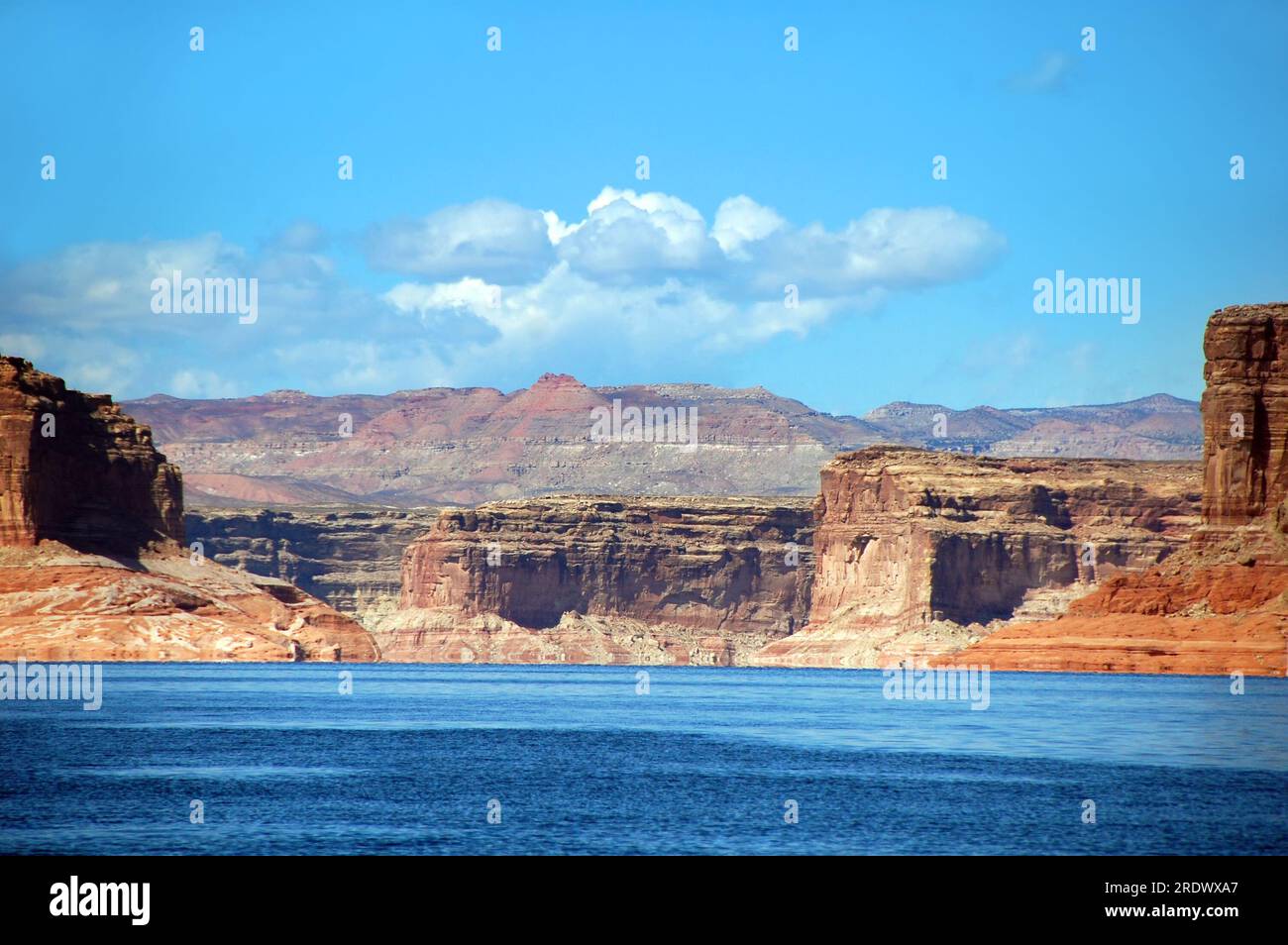 Lake Powell in Arizona is surrounded by towering cliffs and views of ...