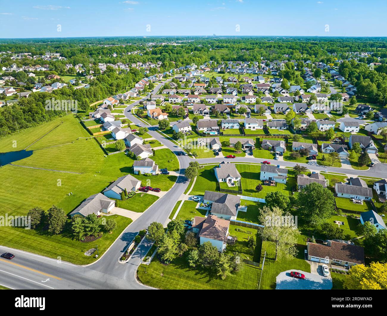 Red cars on neighborhood streets aerial with lots of houses Stock Photo ...