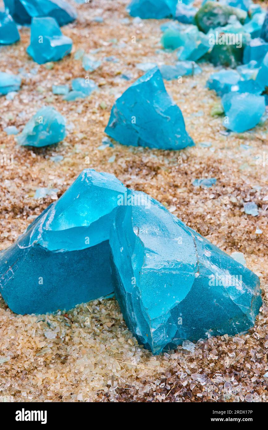 Broken glass fragments sitting on piles of clear busted glass fragments ...