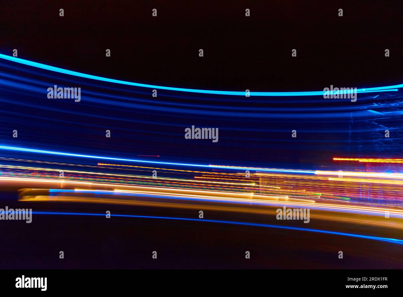 Horizontal curved slash of streaks of blue and yellow and orange neon ...