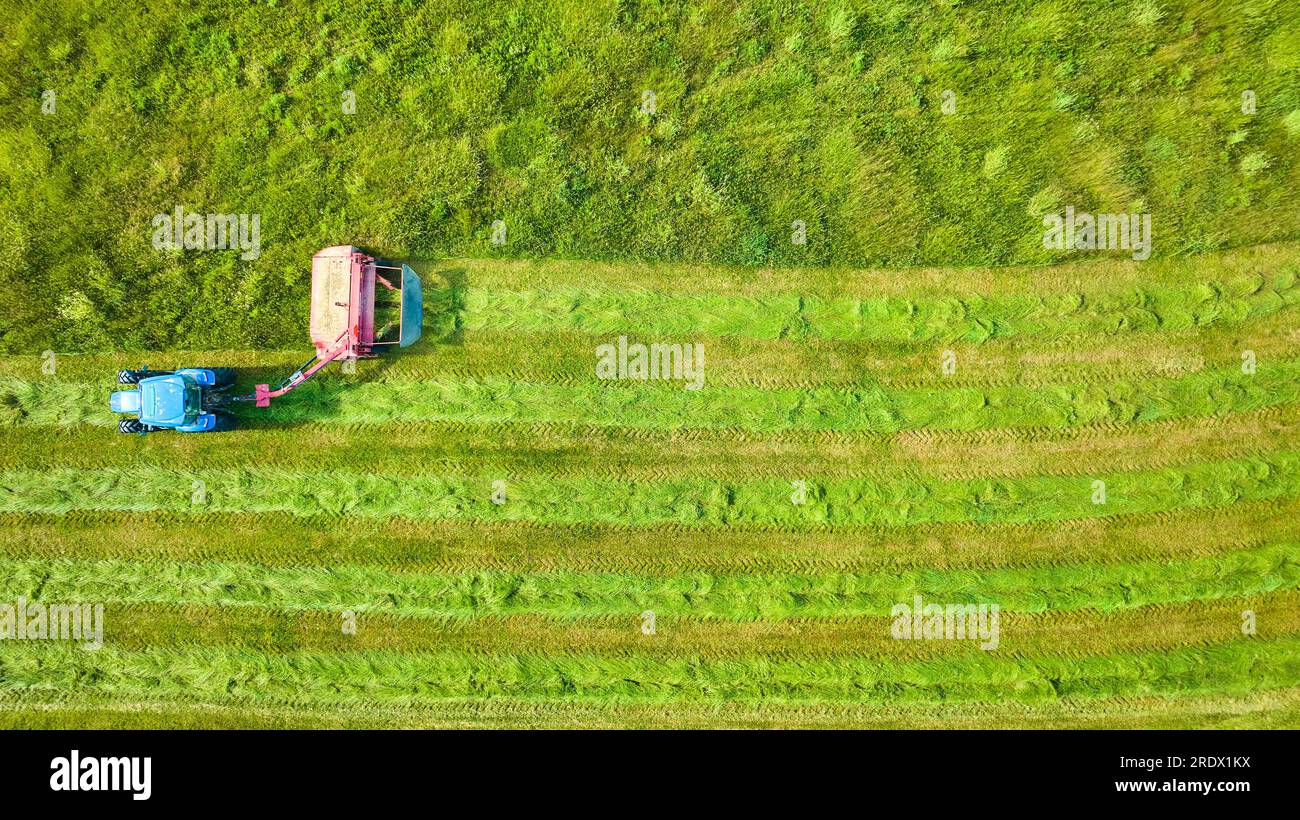 Downward view of tractor mowing weeds in field aerial background asset ...