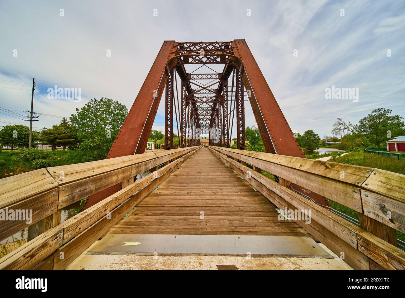 Entrance to walking bridge converted from old rusty railway train track ...