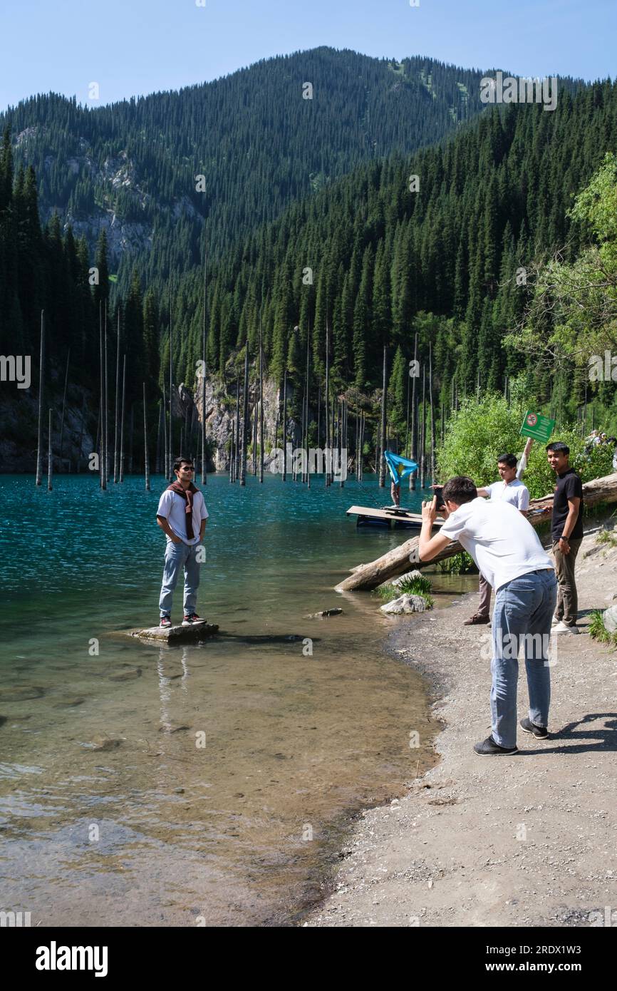 Kazakhstan, Kolsay Lakes National Park. Kaindy Lake. Visitors Pose for ...