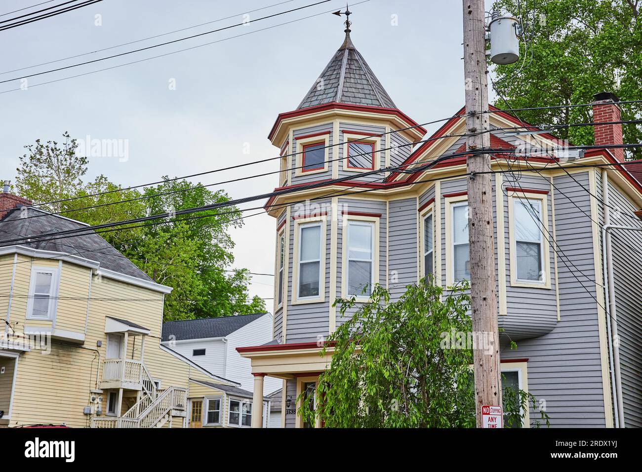 Fancy blue house with partial tower with bay windows and red trim with ...