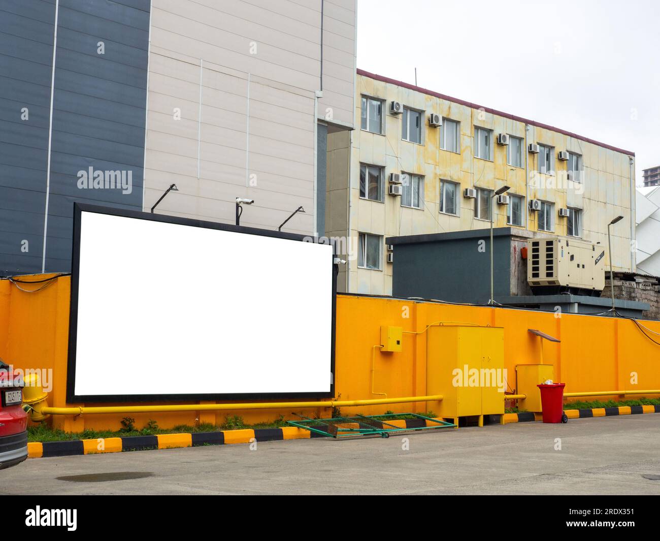 Street advertising in the industrial area. Empty billboard. Place for advertising. Mockup on the ...