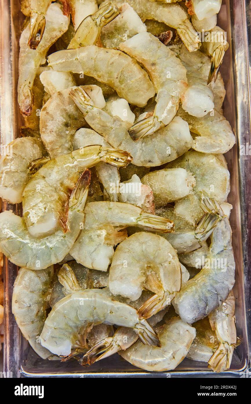Raw shrimp, see through, dead, uncooked, container at grocery store ...