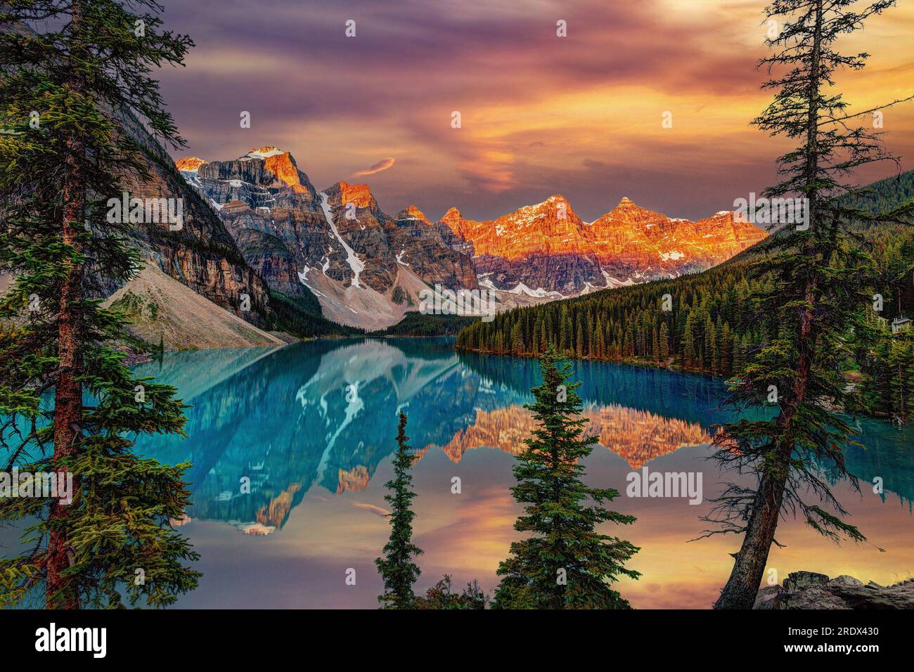 Golden sunrise over the Valley of the Ten Peaks with glacier-fed, turquoise-colored Moraine Lake ...