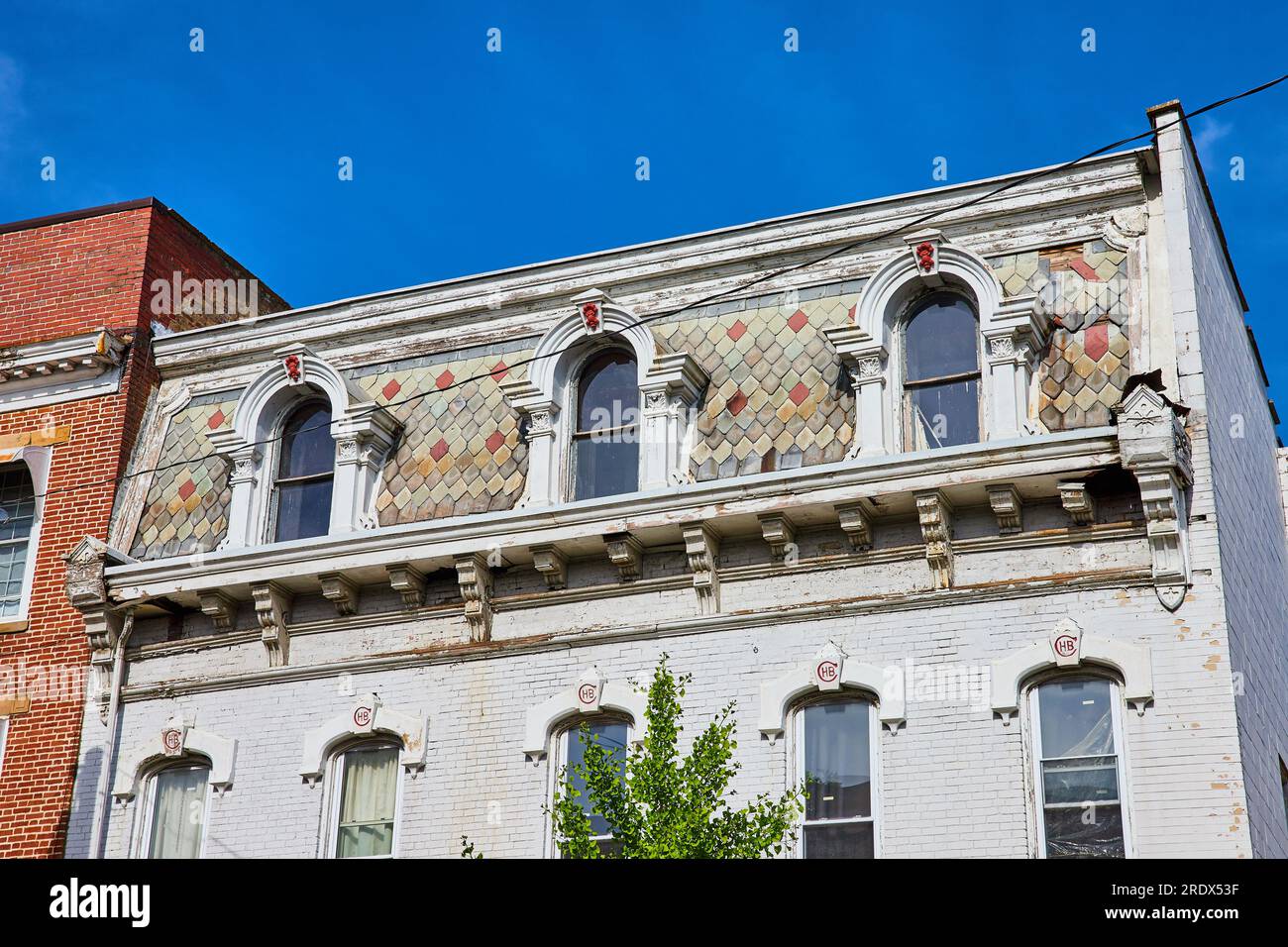 Unique colorful tile siding on white brick roof building in Public ...