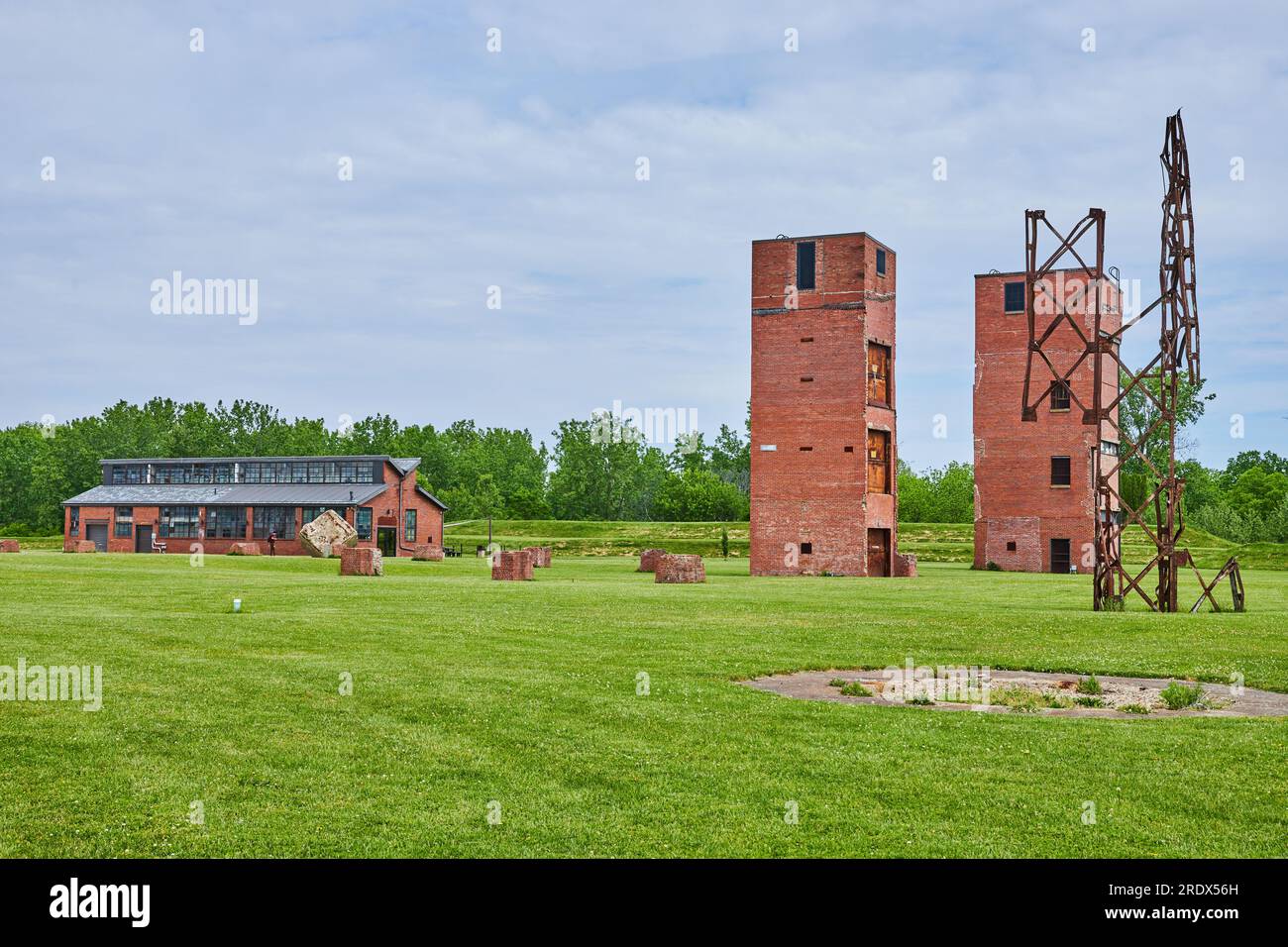 Rusty tower in front of destroyed factory with freight elevators and ...