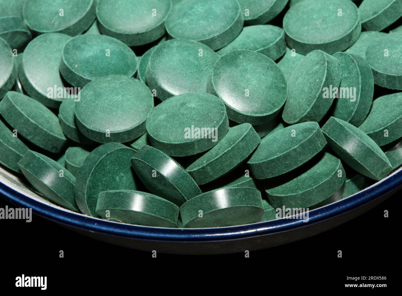 Green round healthy pills close up medical spirulina platensis space ...