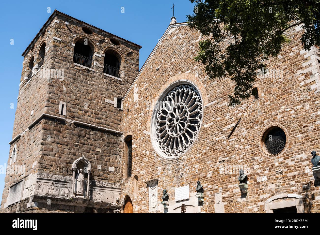 The façade and the bell tower of Saint Justus cathedral built in 14th ...