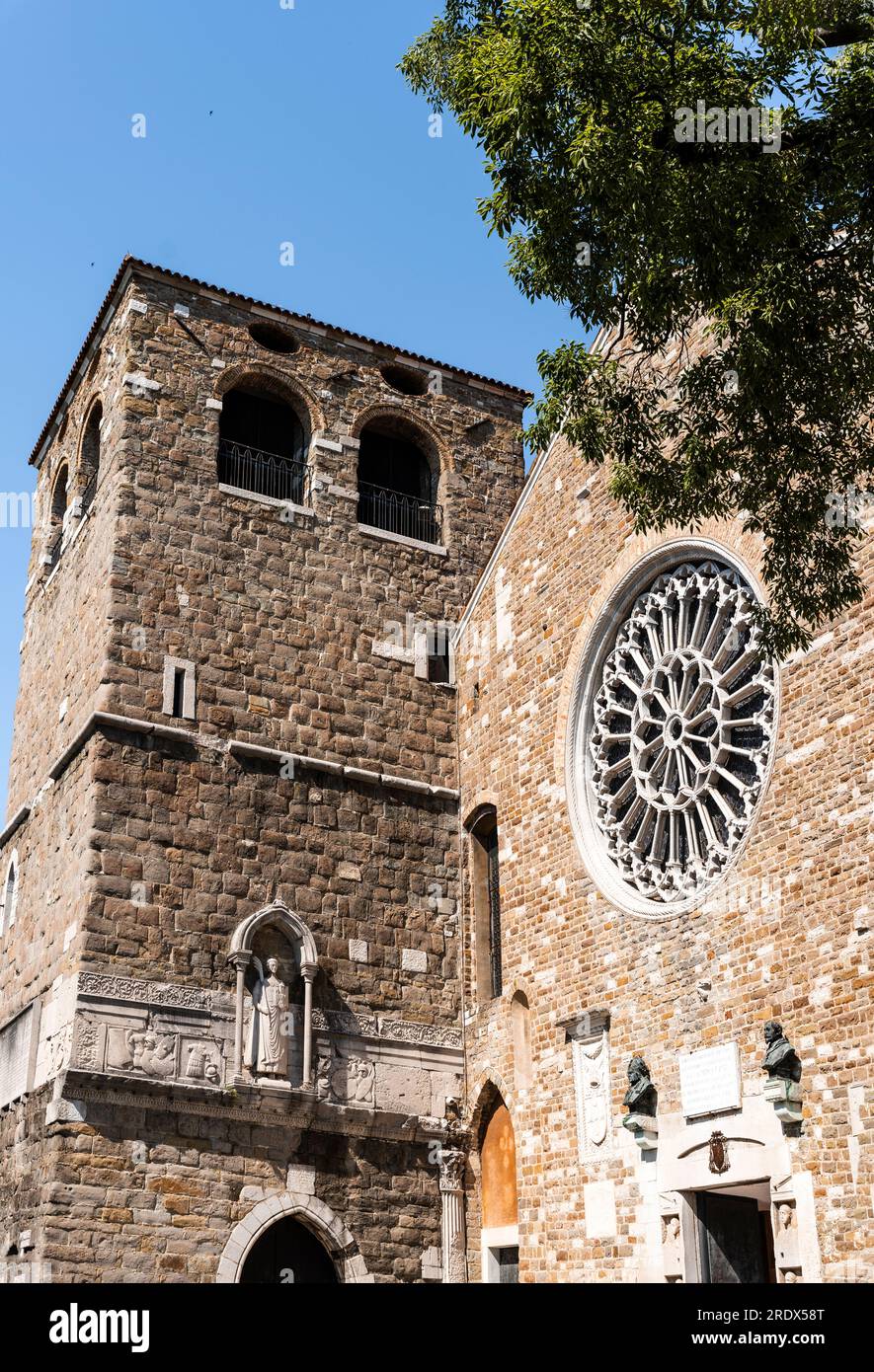 The façade and the bell tower of Saint Justus cathedral built in 14th ...