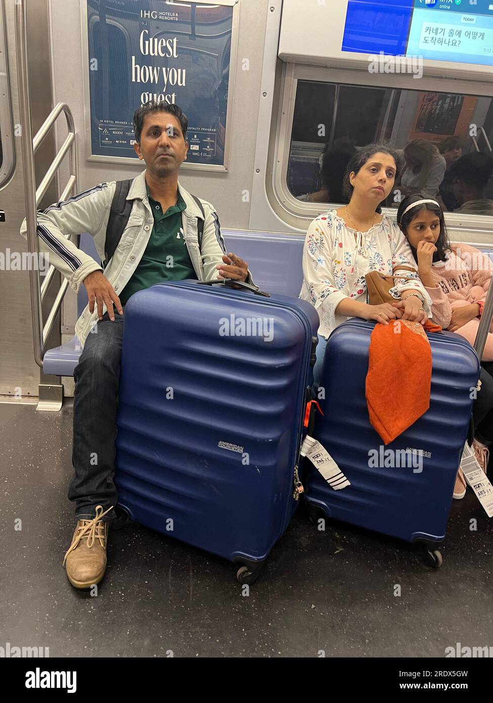 Family with luggage on a New York City subway train Stock Photo - Alamy