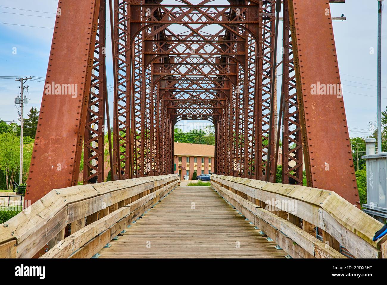 Tall beams reaching up from old rusty railroad bridge converted into ...