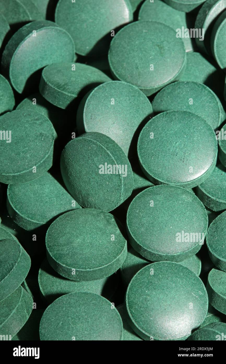 Green round healthy pills close up medical spirulina platensis space ...