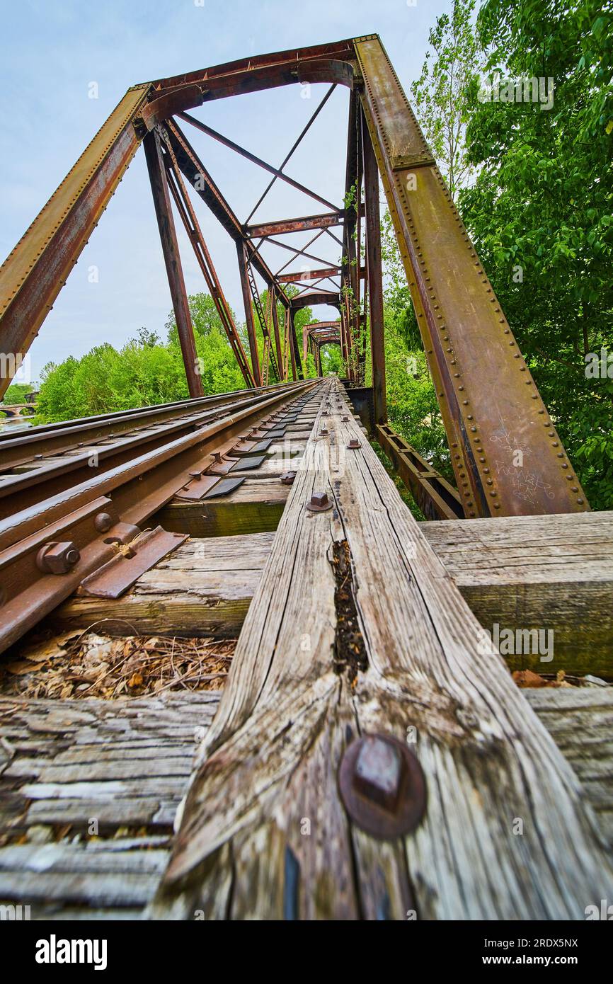 Vertical of wooden beam with nuts and bolts that spans length of truss ...