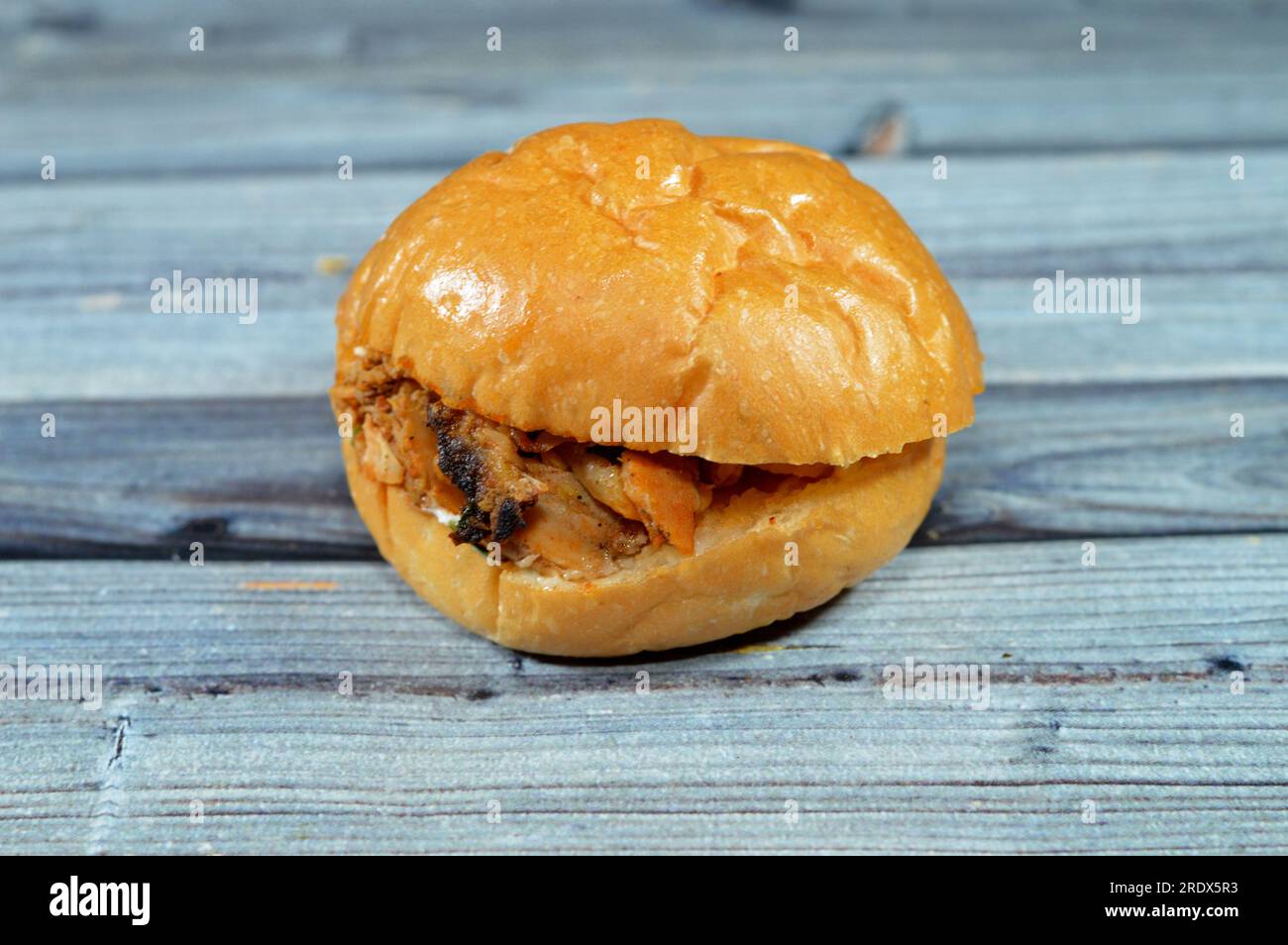 Chicken shawarma sandwich in a a bun, a popular Middle Eastern dish ...