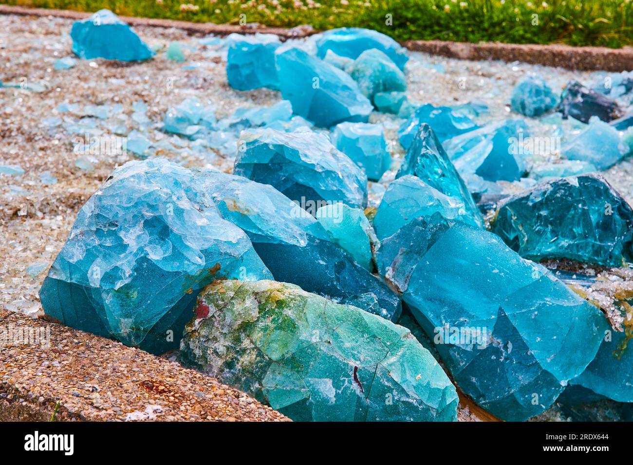 Beautiful blue glass shards sitting in pile of white glass fragments in ...